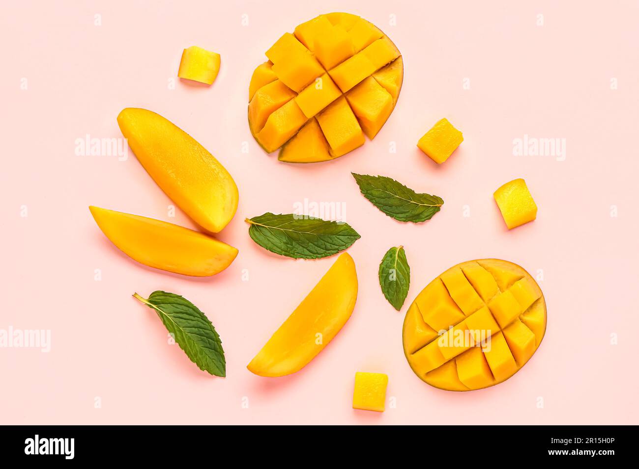 Fresh cut mangoes on light pink background Stock Photo - Alamy