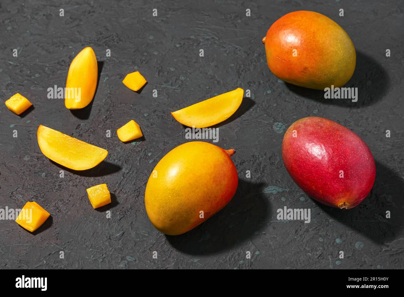 Fresh ripe mangoes on black background Stock Photo - Alamy