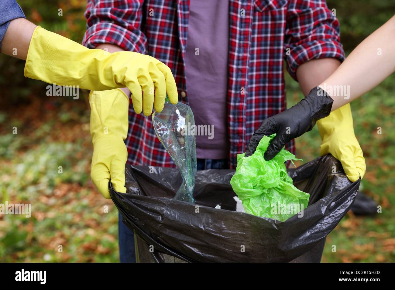People with plastic bag collecting garbage in park, closeup Stock Photo ...