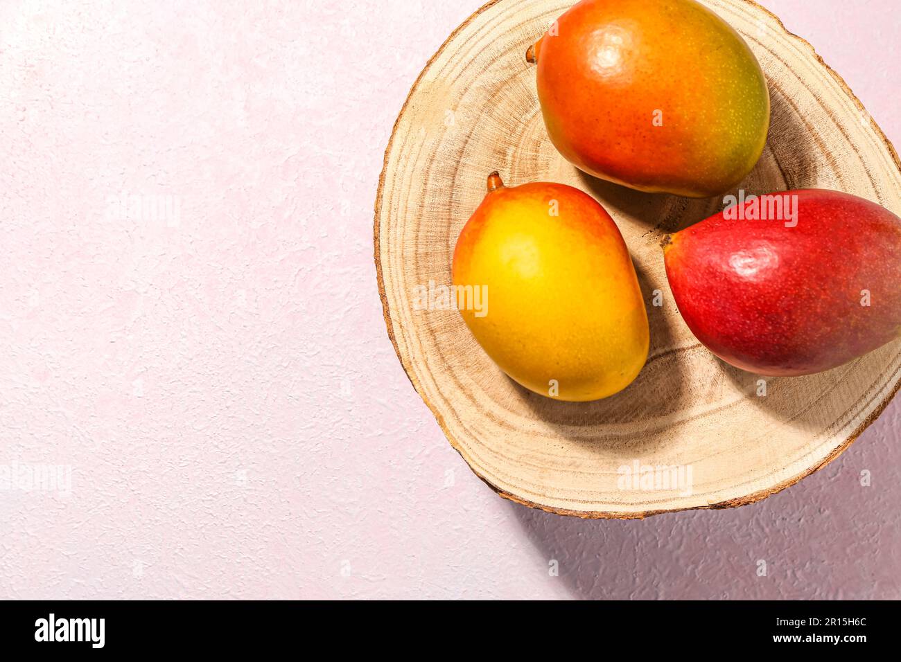 Fresh ripe mangoes on light background Stock Photo - Alamy