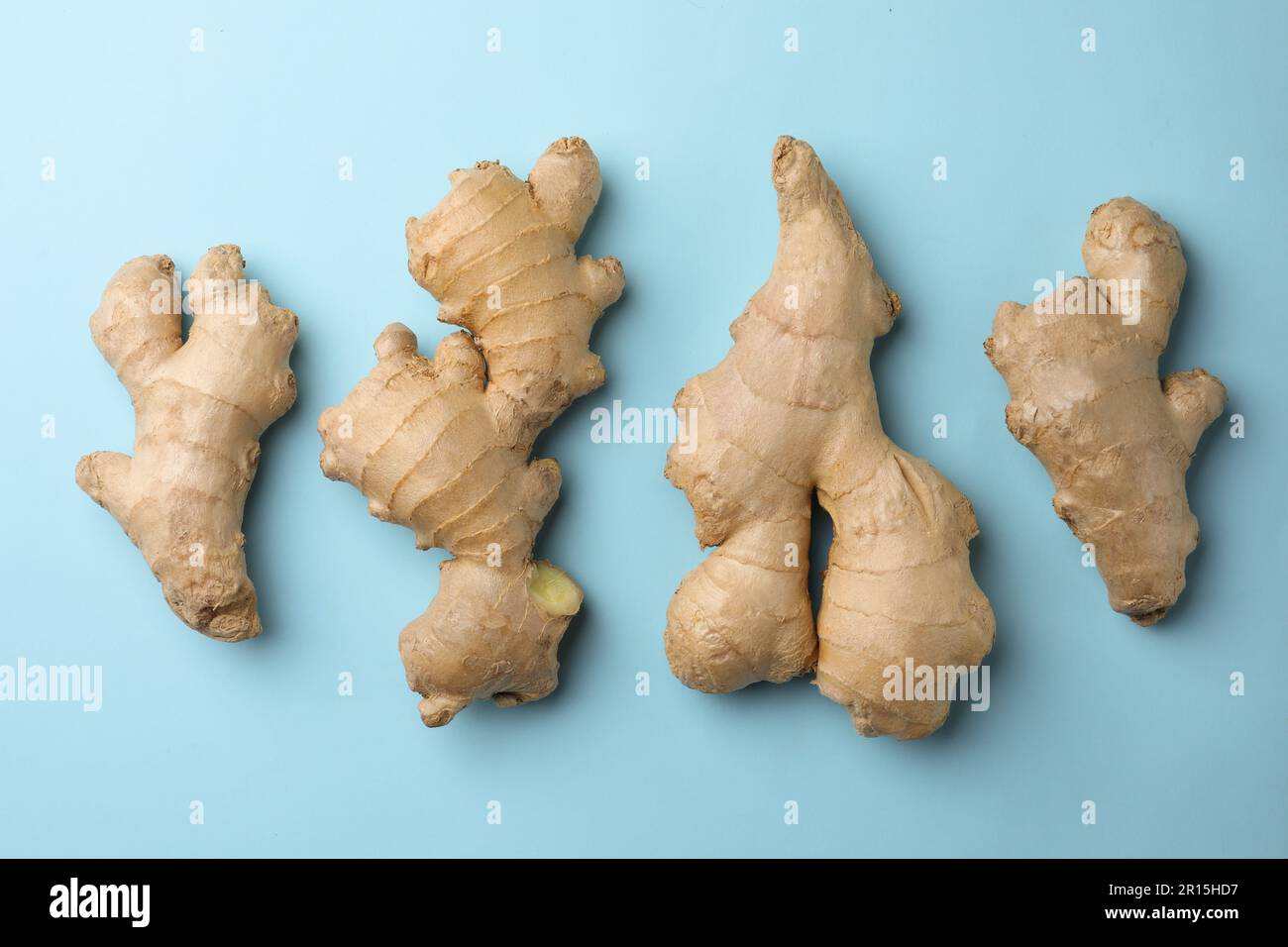 Fresh ginger on pale light blue background, flat lay Stock Photo - Alamy