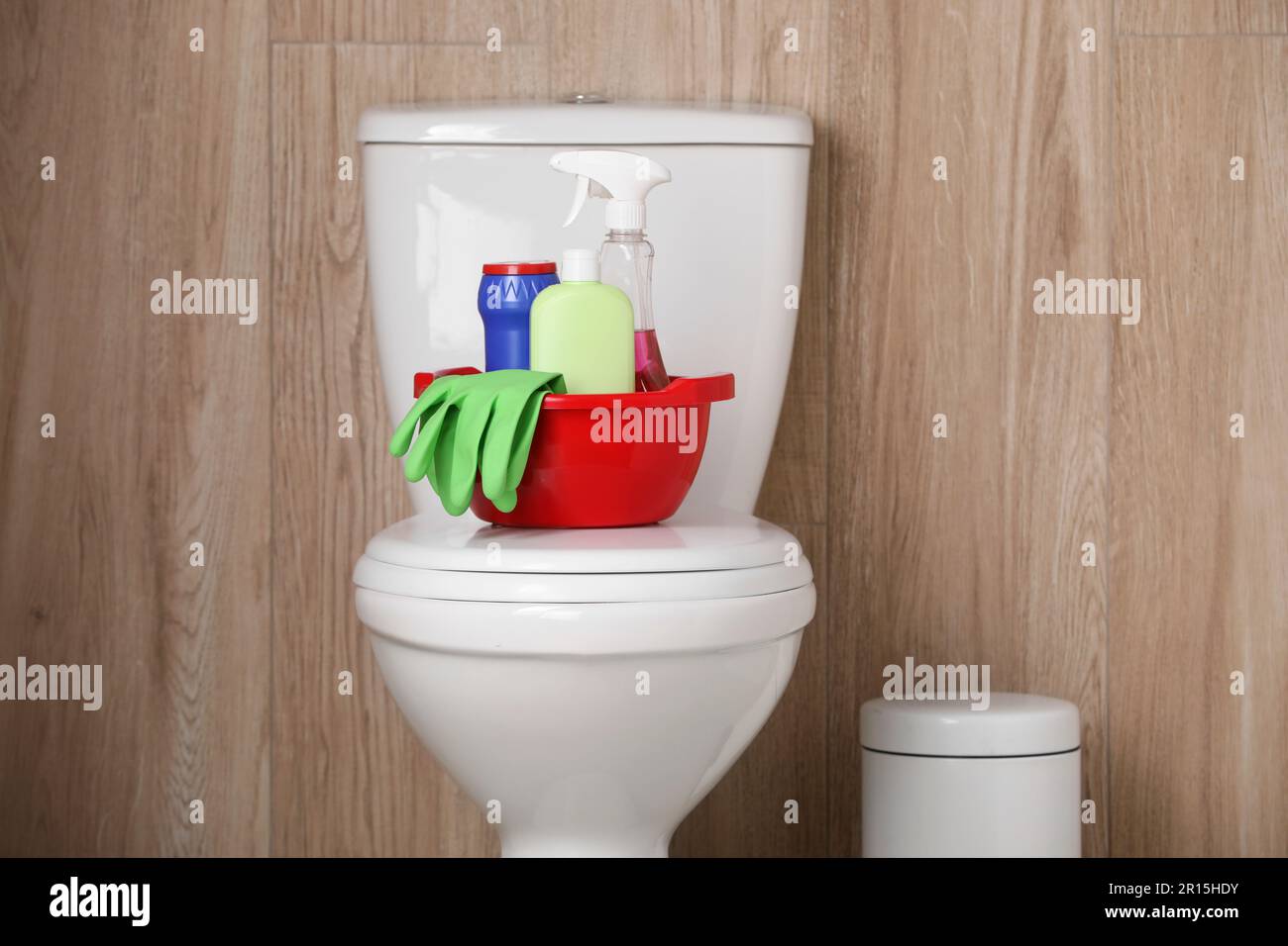 Different cleaning supplies on toilet bowl indoors Stock Photo - Alamy