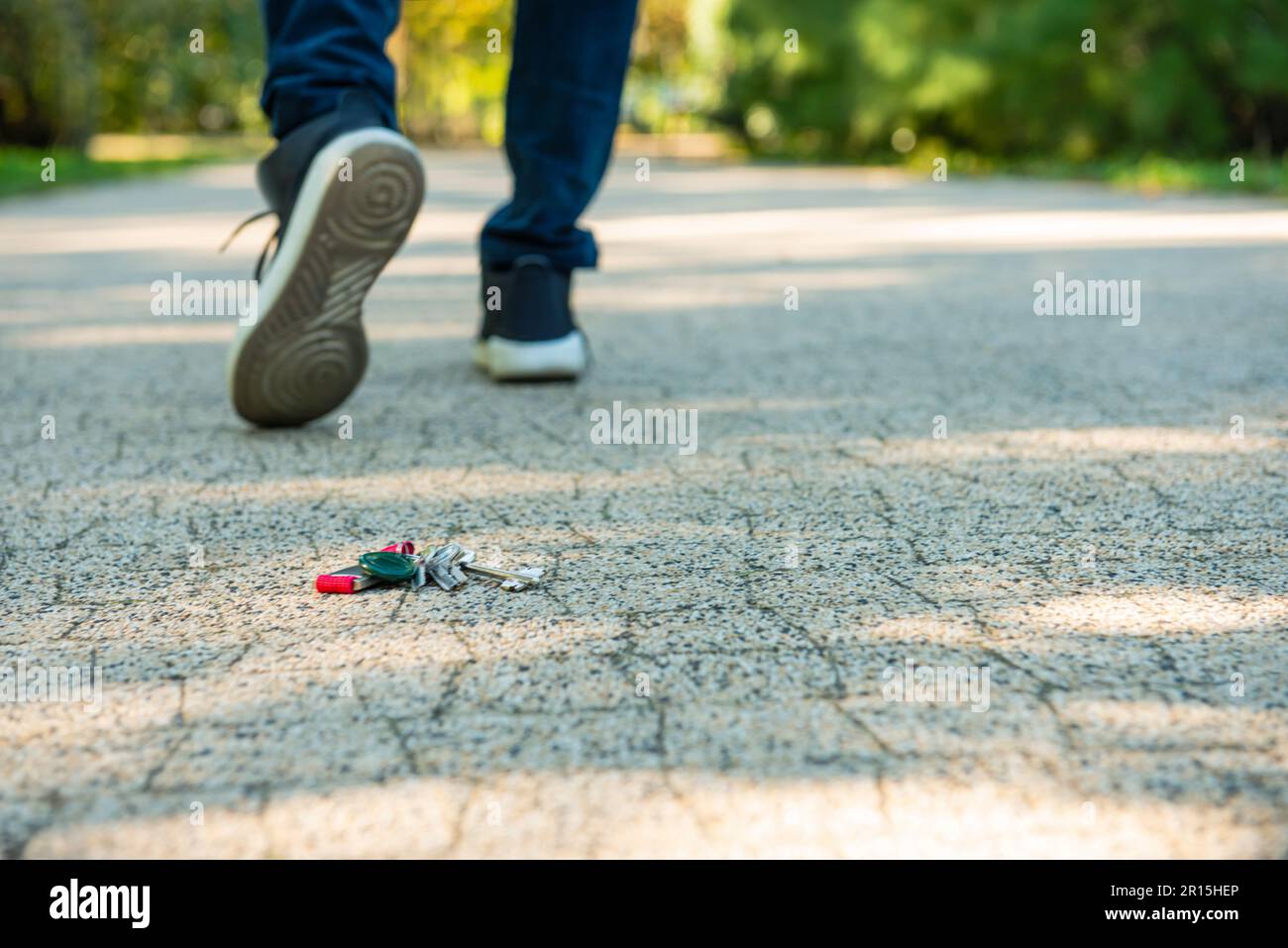 Man walking outside, focus on lost keys. Space for text Stock Photo - Alamy