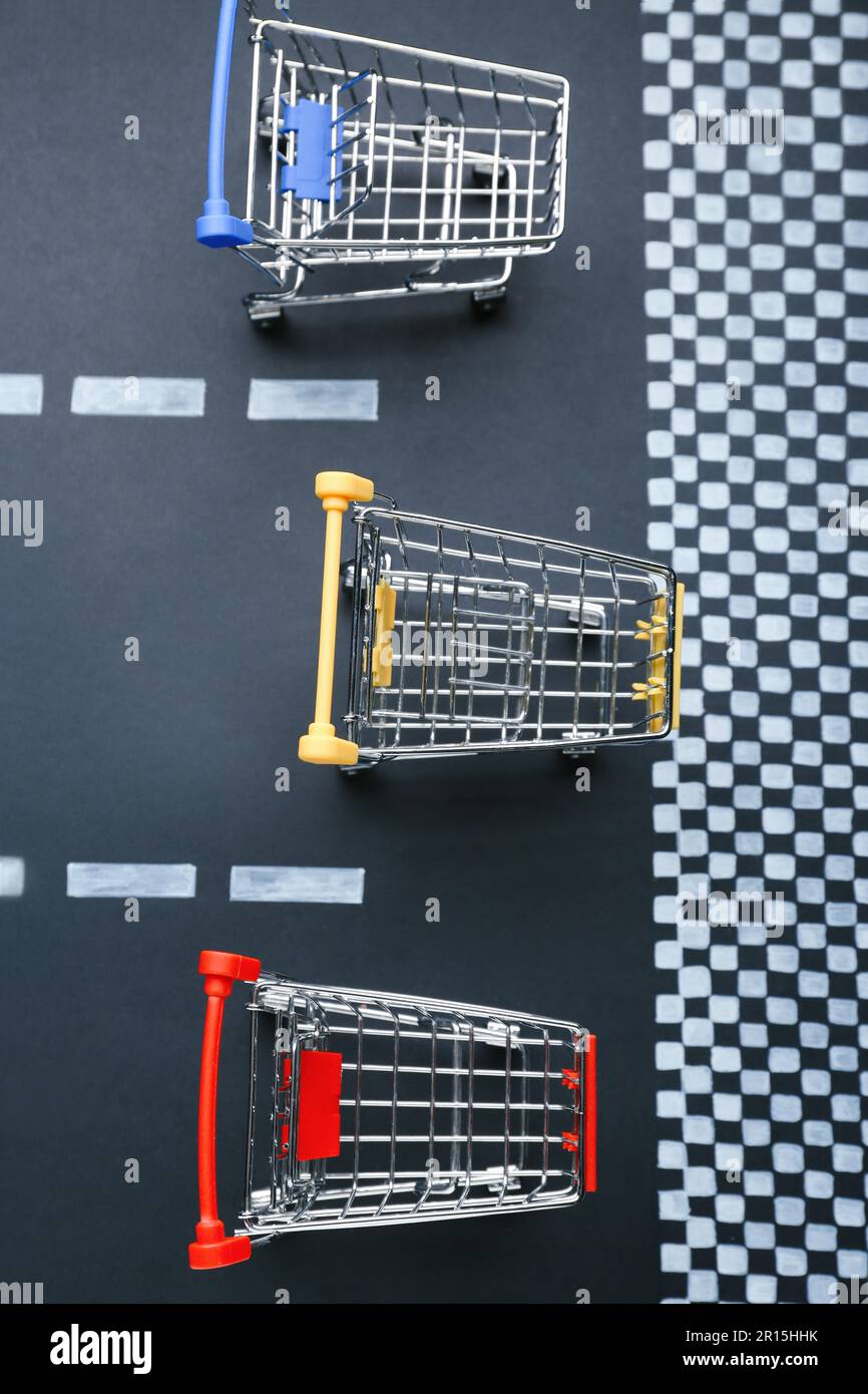 Competition concept. Shopping carts racing towards finish line, flat ...
