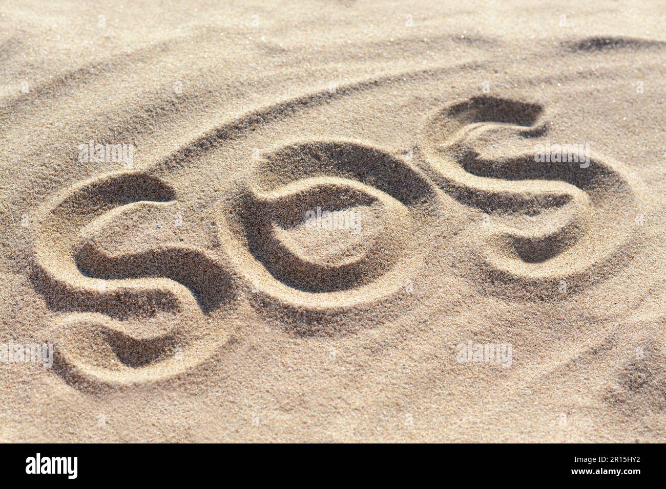 Sos message written on sand hi-res stock photography and images - Alamy