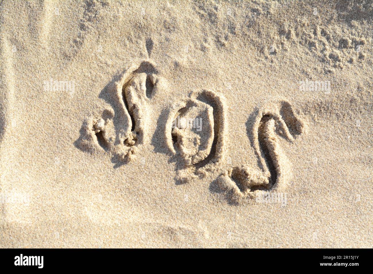 SOS message written on sandy beach outdoors, top view Stock Photo - Alamy