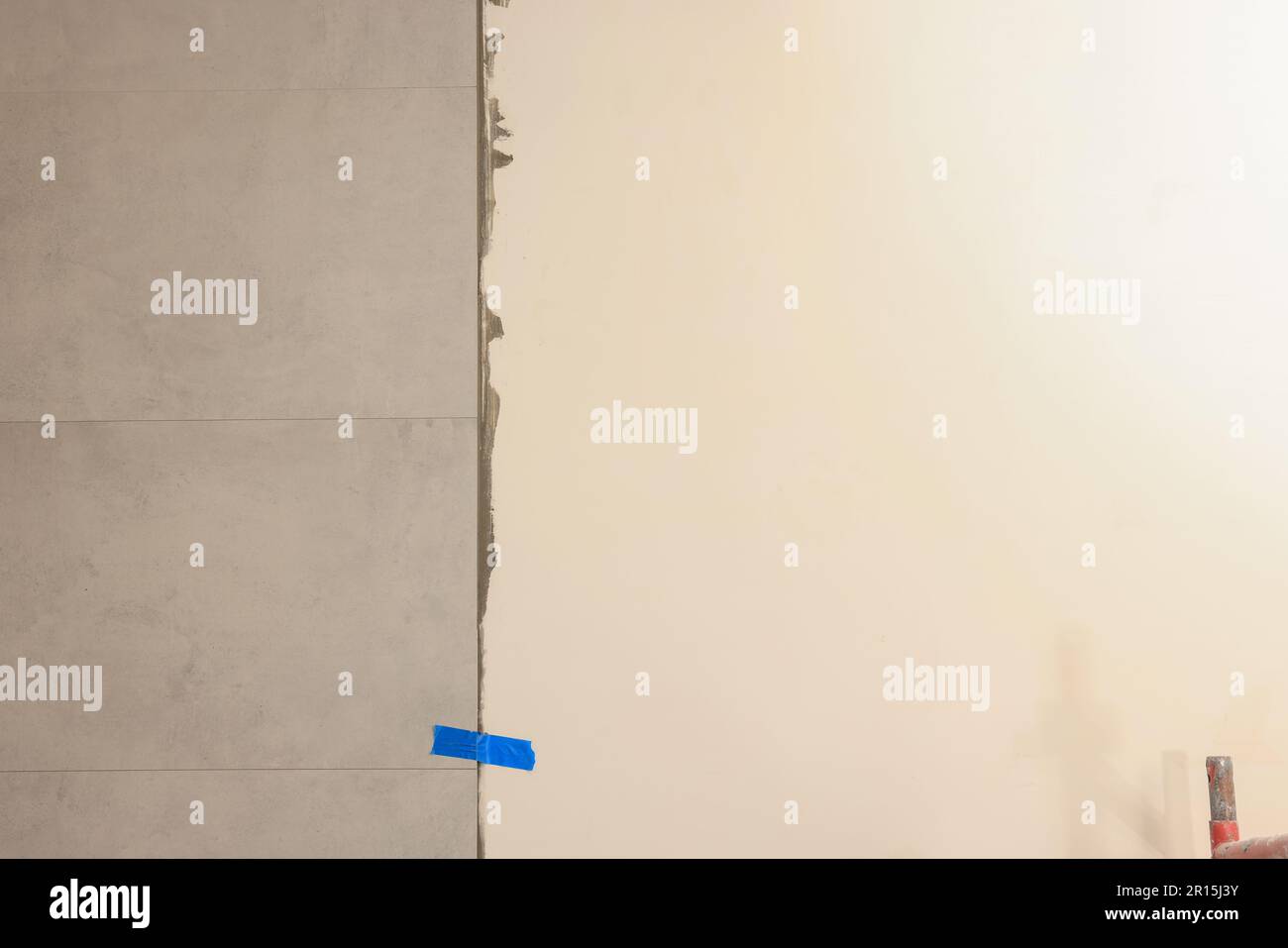 Adhesive mix with tiles on white wall Stock Photo - Alamy