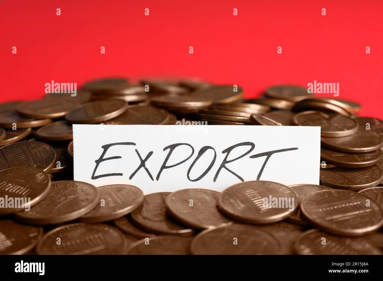 Sheet of paper with word Export and coins on red background, closeup ...