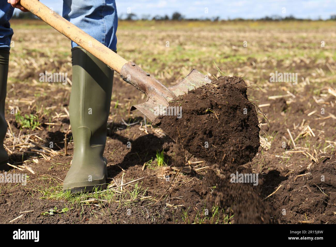 Man digging soil with shovel in field, closeup Stock Photo - Alamy