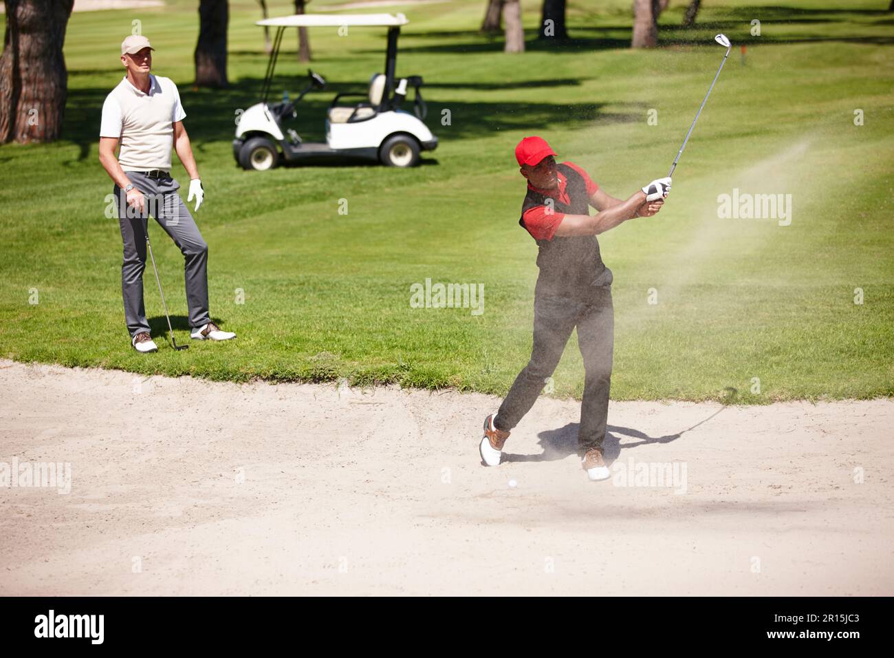 Getting their golf on. two handsome men playing a game of golf Stock ...