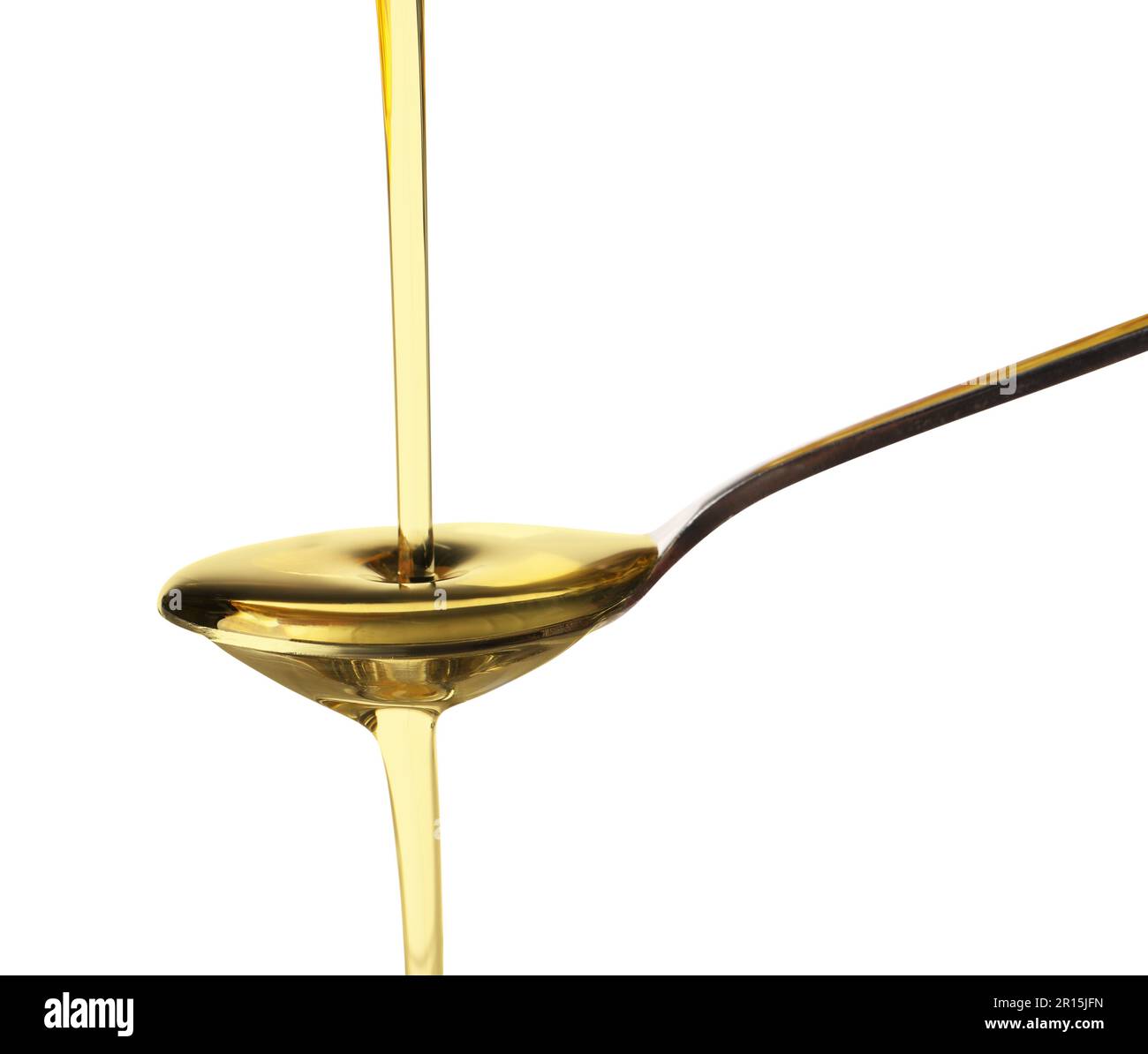 Pouring cooking oil into spoon on white background Stock Photo - Alamy