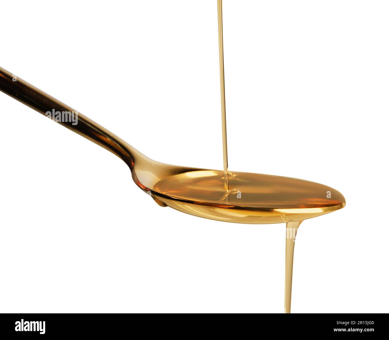 Pouring cooking oil into spoon on white background Stock Photo - Alamy