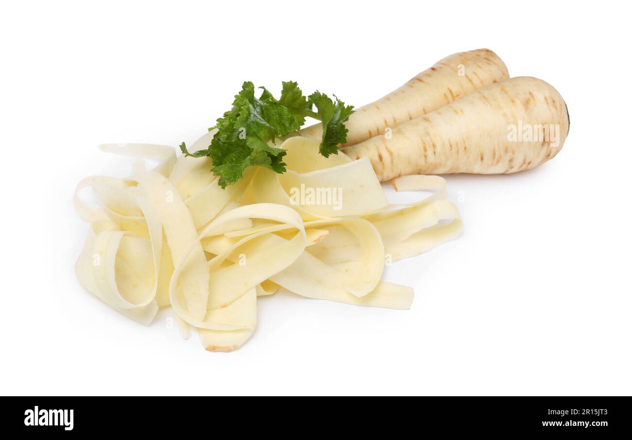 Whole and sliced fresh ripe parsnip with leaves on white background ...