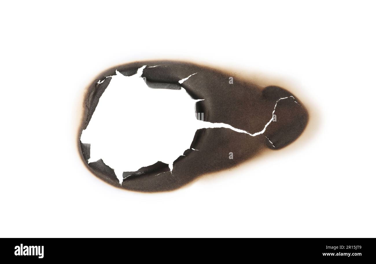 Burnt hole in paper on white background Stock Photo - Alamy