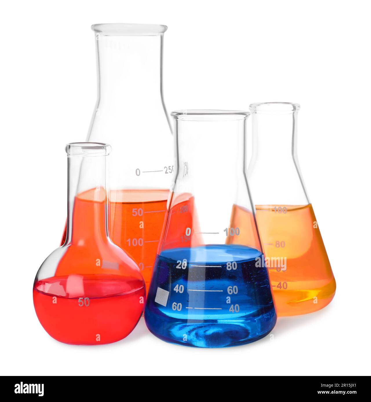 Different laboratory glassware with colorful liquids on white ...