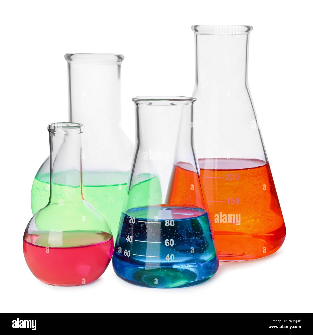 Different laboratory glassware with colorful liquids on white ...