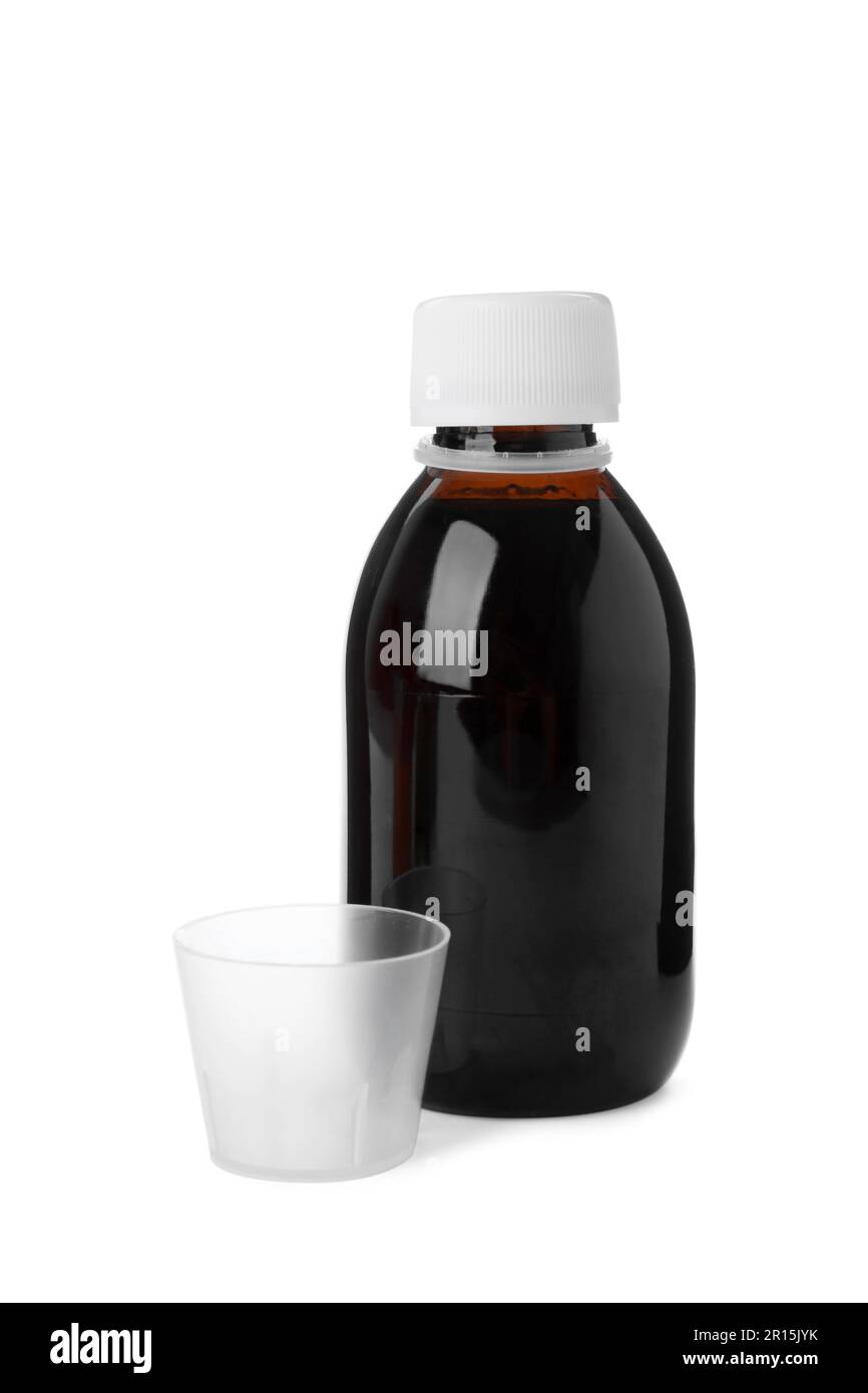 Bottle of syrup with measuring cup on white background. Cough and cold ...