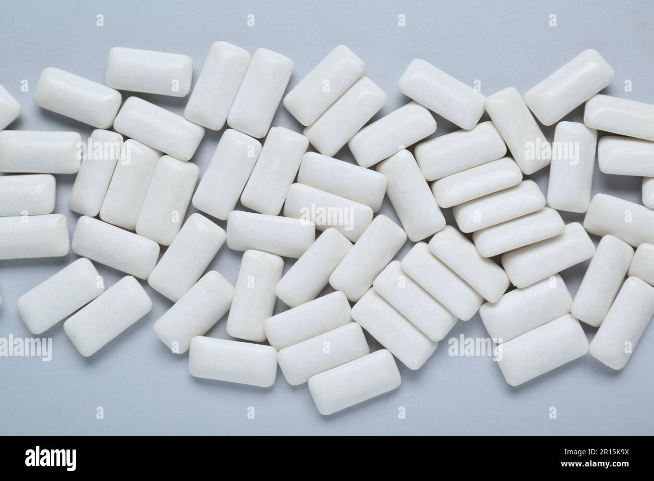 Tasty white chewing gums on light grey background, flat lay Stock Photo ...