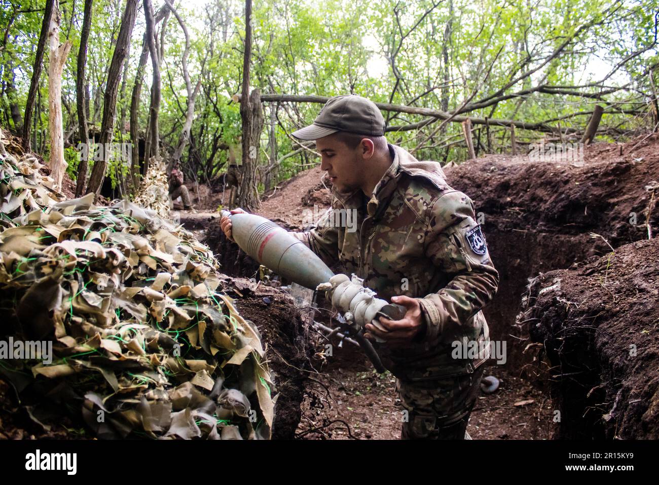 Ukrainian soldier from the 28th Artillery Battalion firing a 120mm ...