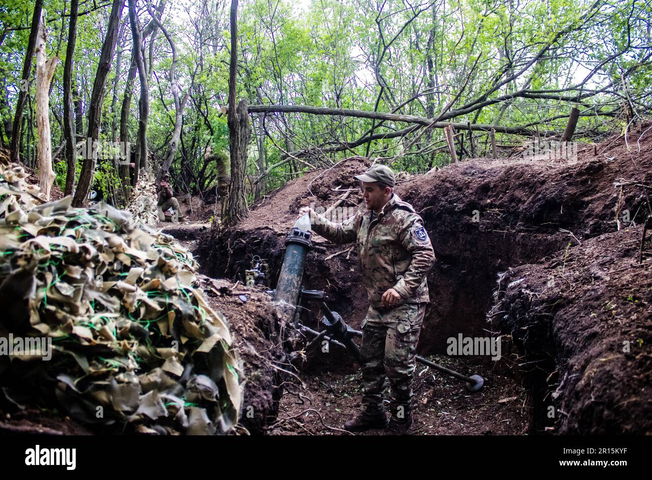 Ukrainian soldier from the 28th Artillery Battalion firing a 120mm ...