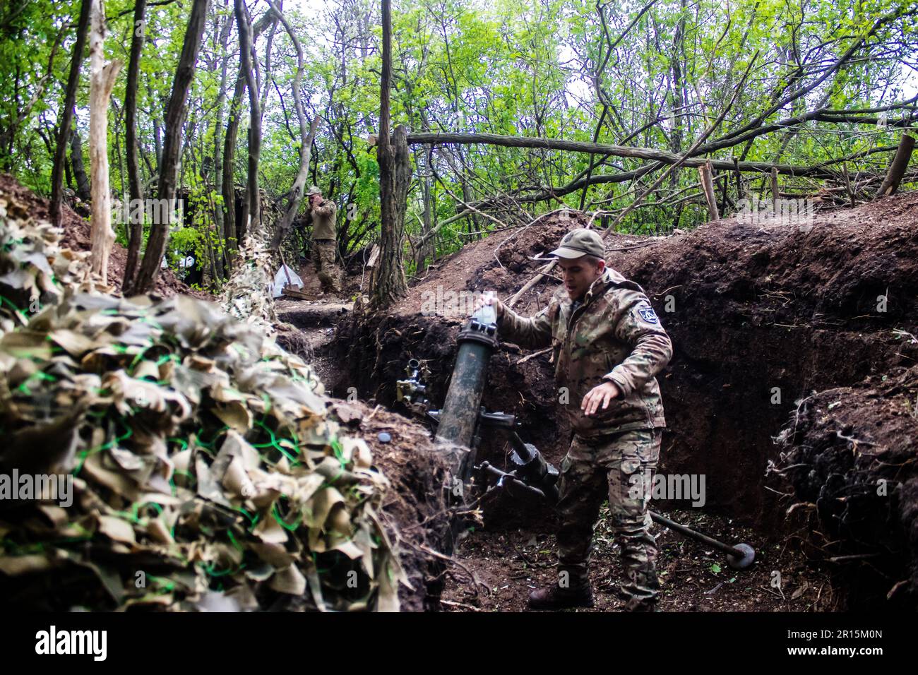 Ukrainian soldier from the 28th Artillery Battalion firing a 120mm ...
