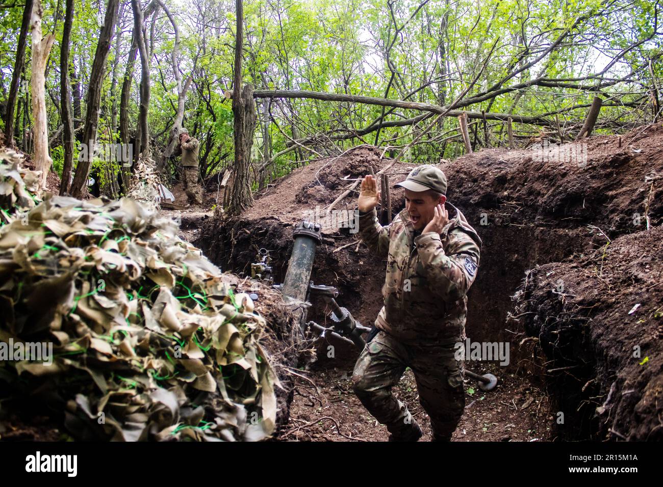 Ukrainian soldier from the 28th Artillery Battalion firing a 120mm ...