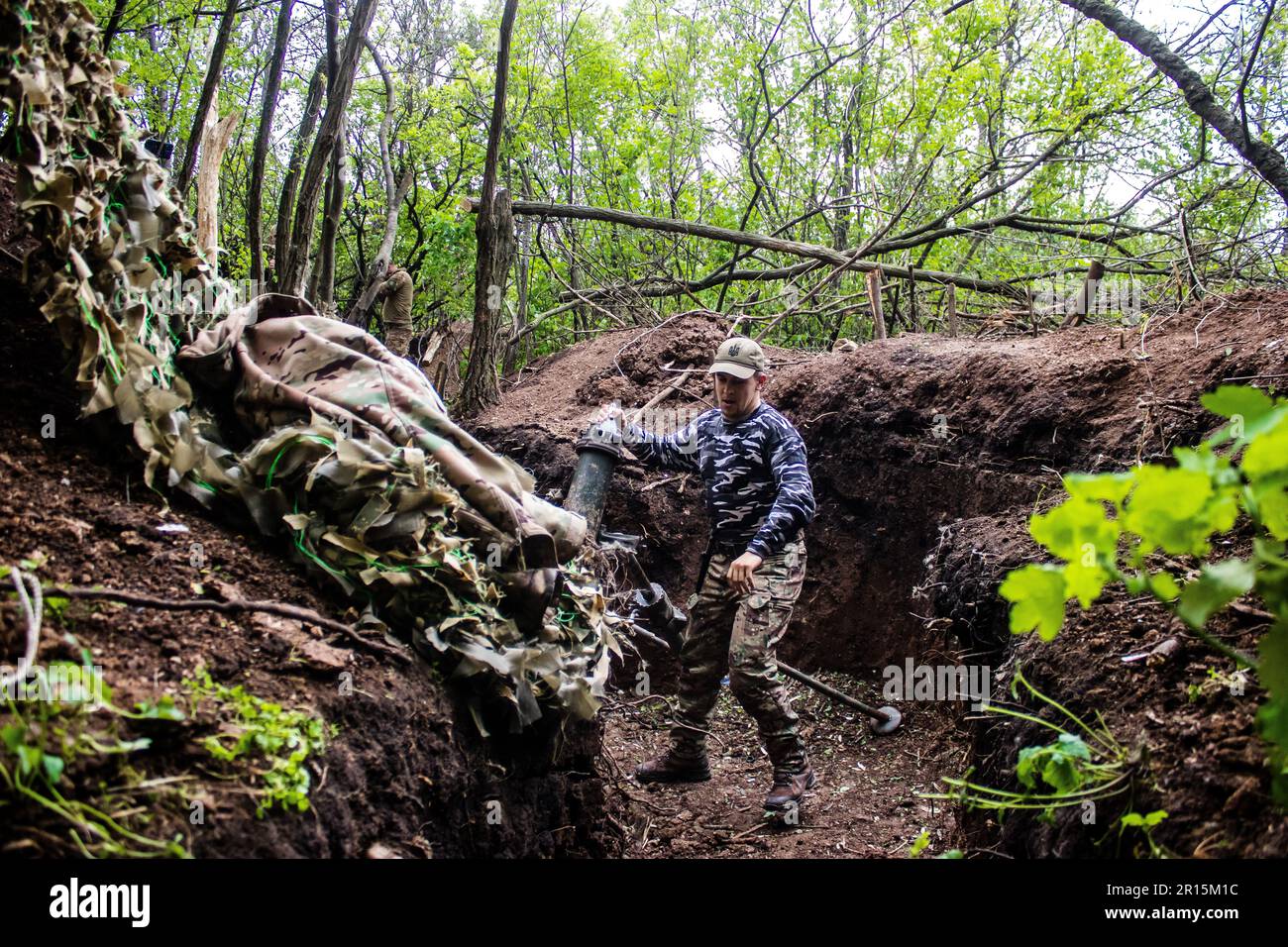 Ukrainian soldier from the 28th Artillery Battalion firing a 120mm ...