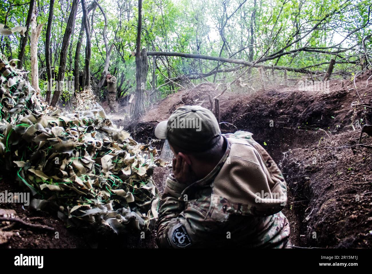 Ukrainian soldier from the 28th Artillery Battalion firing a 120mm ...