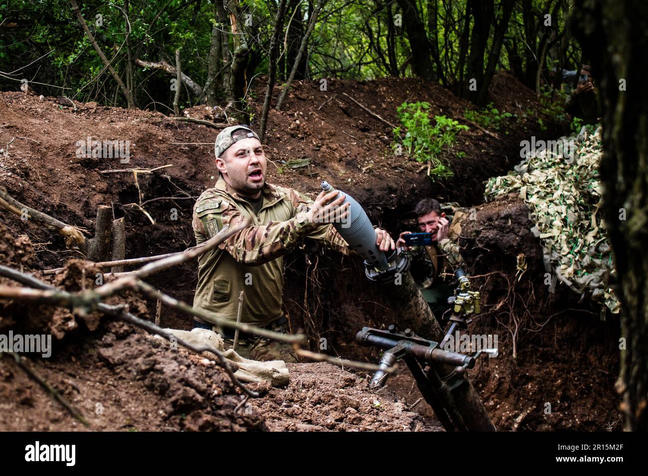Ukrainian soldier from the 28th Artillery Battalion firing a 120mm ...