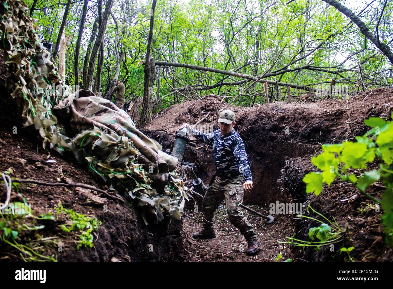 Ukrainian soldier from the 28th Artillery Battalion firing a 120mm ...