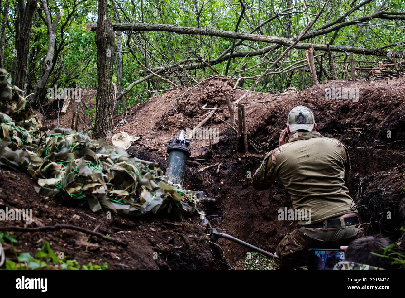 Ukrainian soldier from the 28th Artillery Battalion firing a 120mm ...