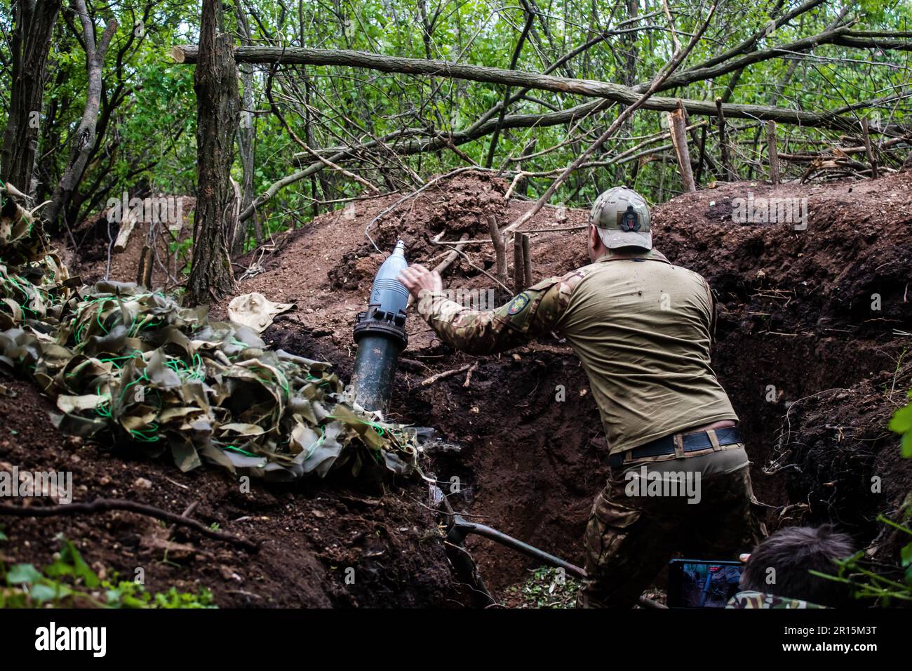 Ukrainian soldier from the 28th Artillery Battalion firing a 120mm ...