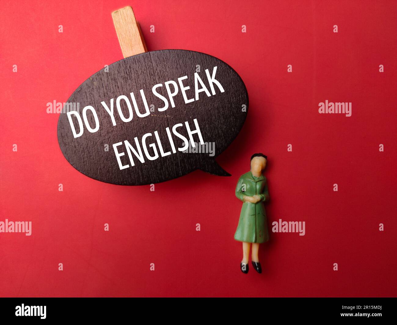 Wooden board and miniature people with the word DO YOU SPEAK ENGLISH on ...