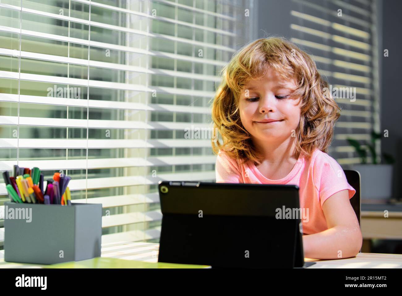 The kid boy ready to answer the online teachers question. E-learning ...