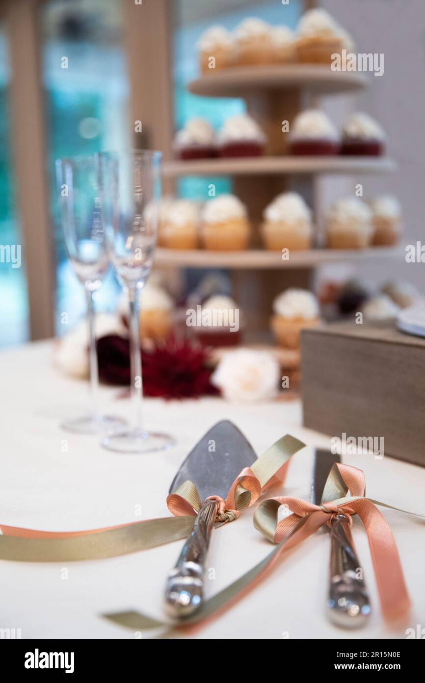 wedding cake serving utensils with wedding cupcake tower out of focus ...