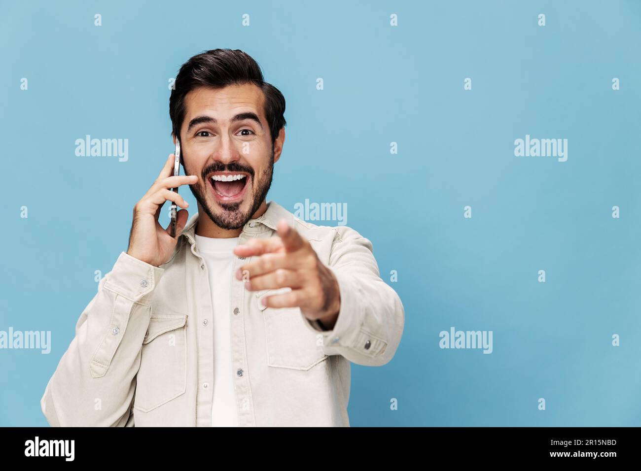 Portrait of a brunette man talking on the phone mobile and internet ...