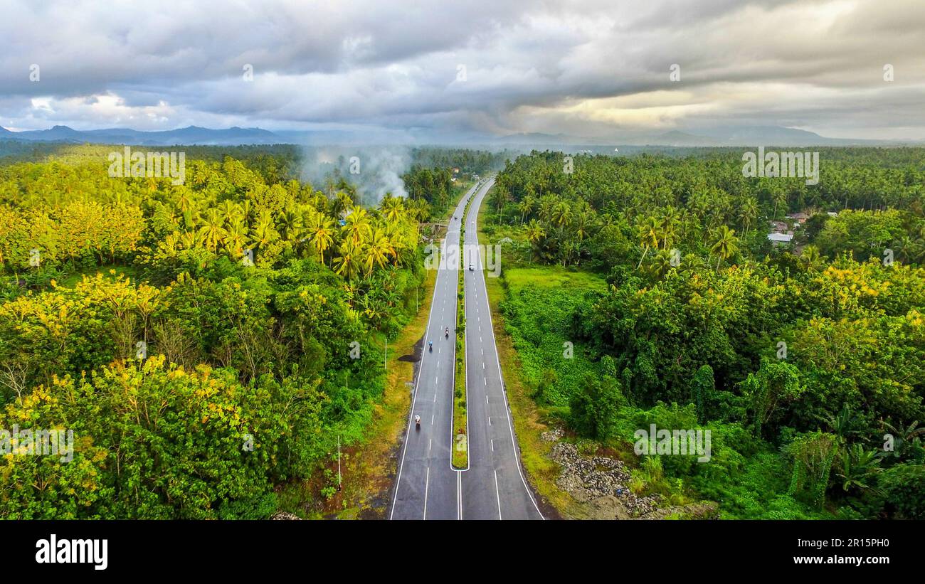 Aerial photo of the highway dividing the forest and villages with a ...