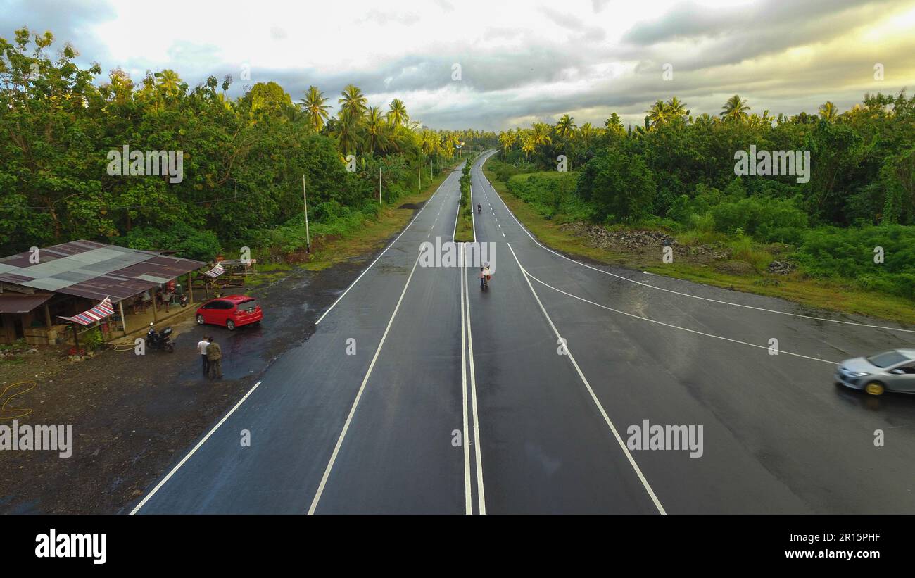Aerial photo of the highway dividing the forest and villages with a ...