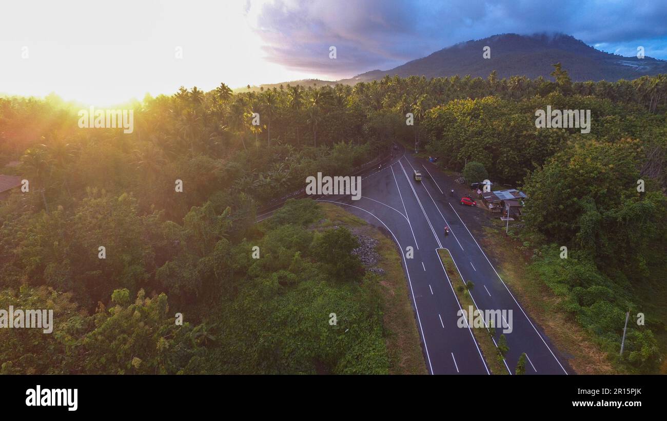 Aerial photo of the highway dividing the forest and villages with a ...