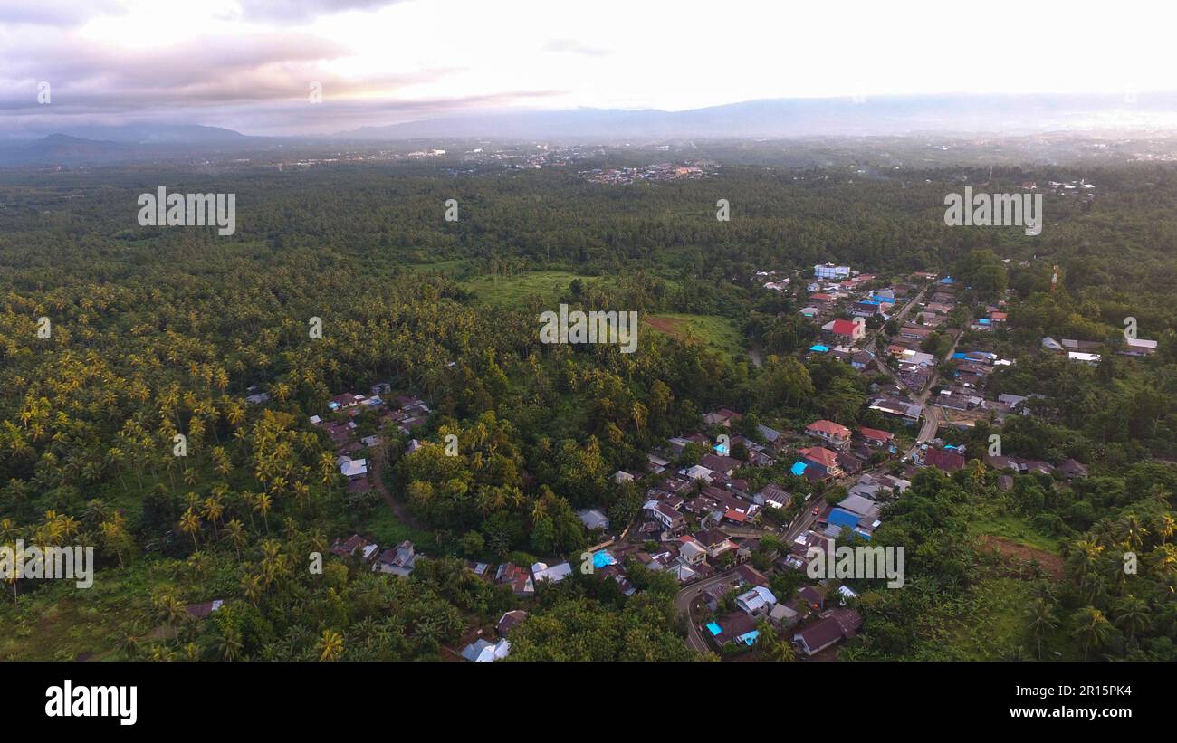 Aerial photo of the highway dividing the forest and villages with a ...