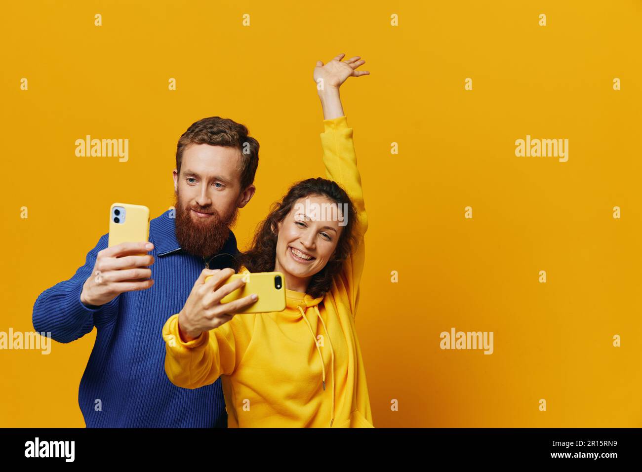 Man and woman couple smiling merrily with phone in hand social media ...