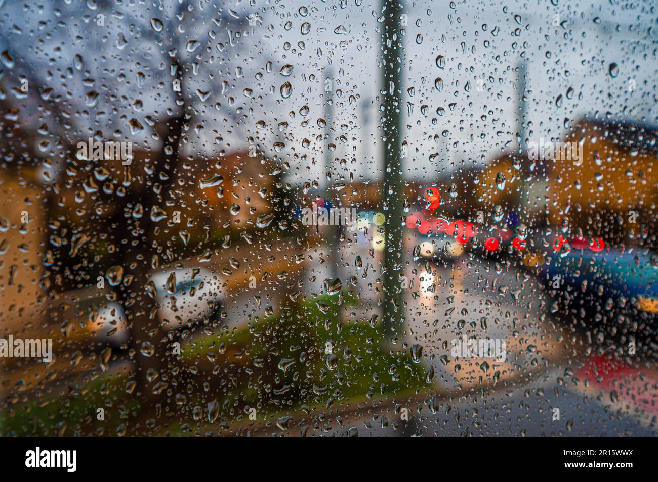 Water drops on a window pane of an apartment building with a view of a ...