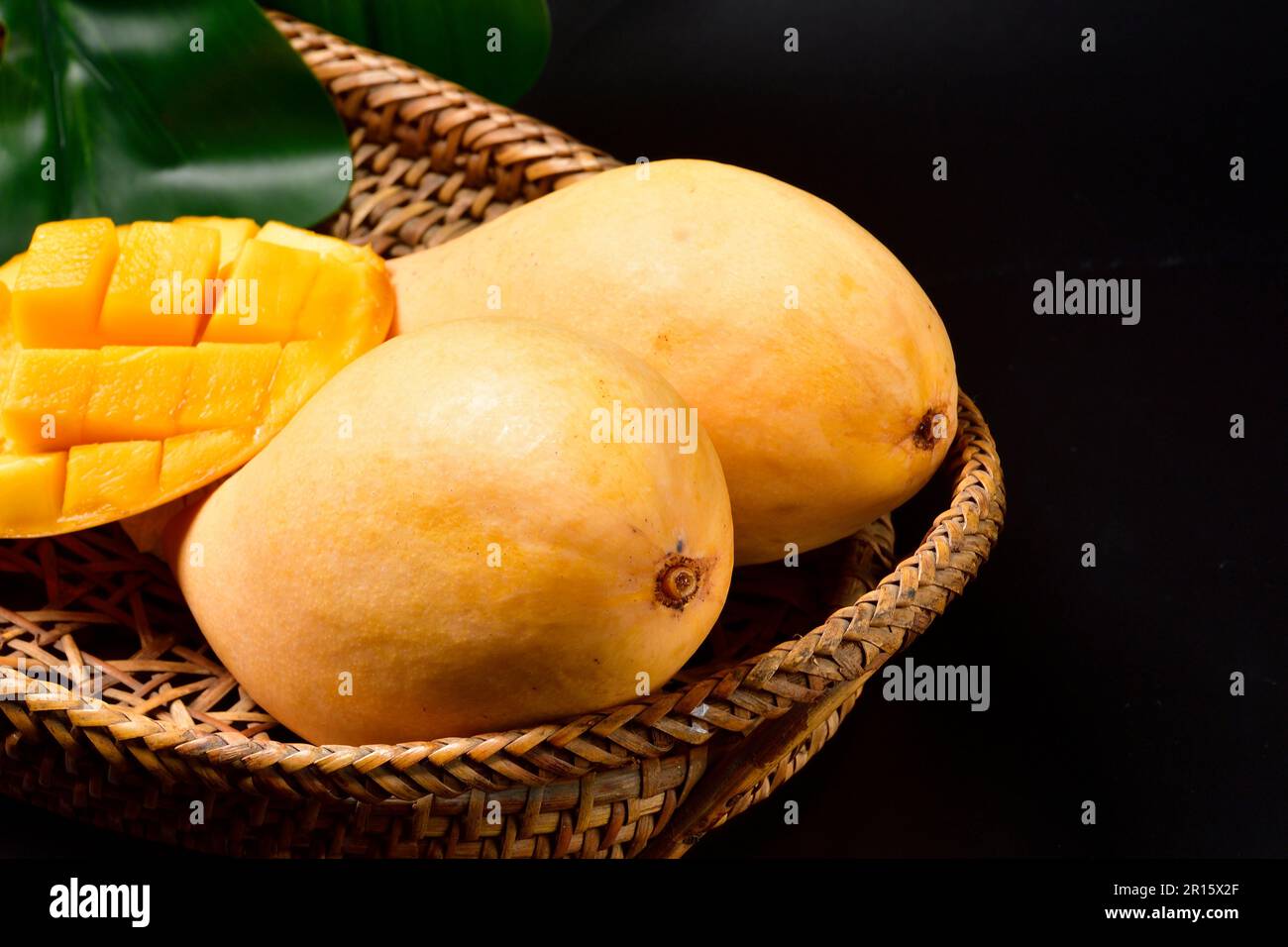 Fresh Thai Mango.Barracuda mango on the wicker basket. Food and drink ...