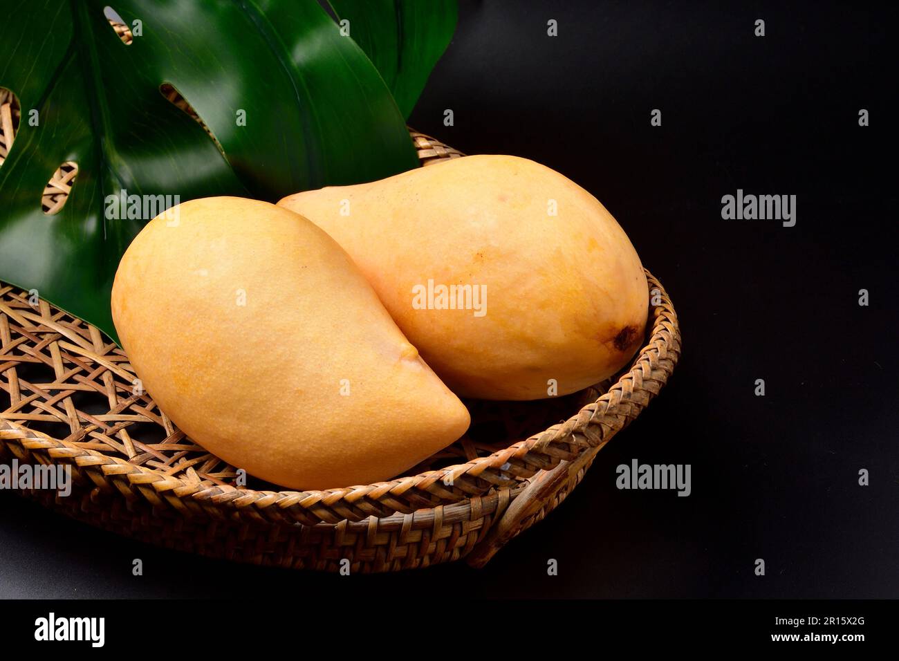 Fresh Thai Mango.Barracuda mango on the wicker basket. Food and drink ...