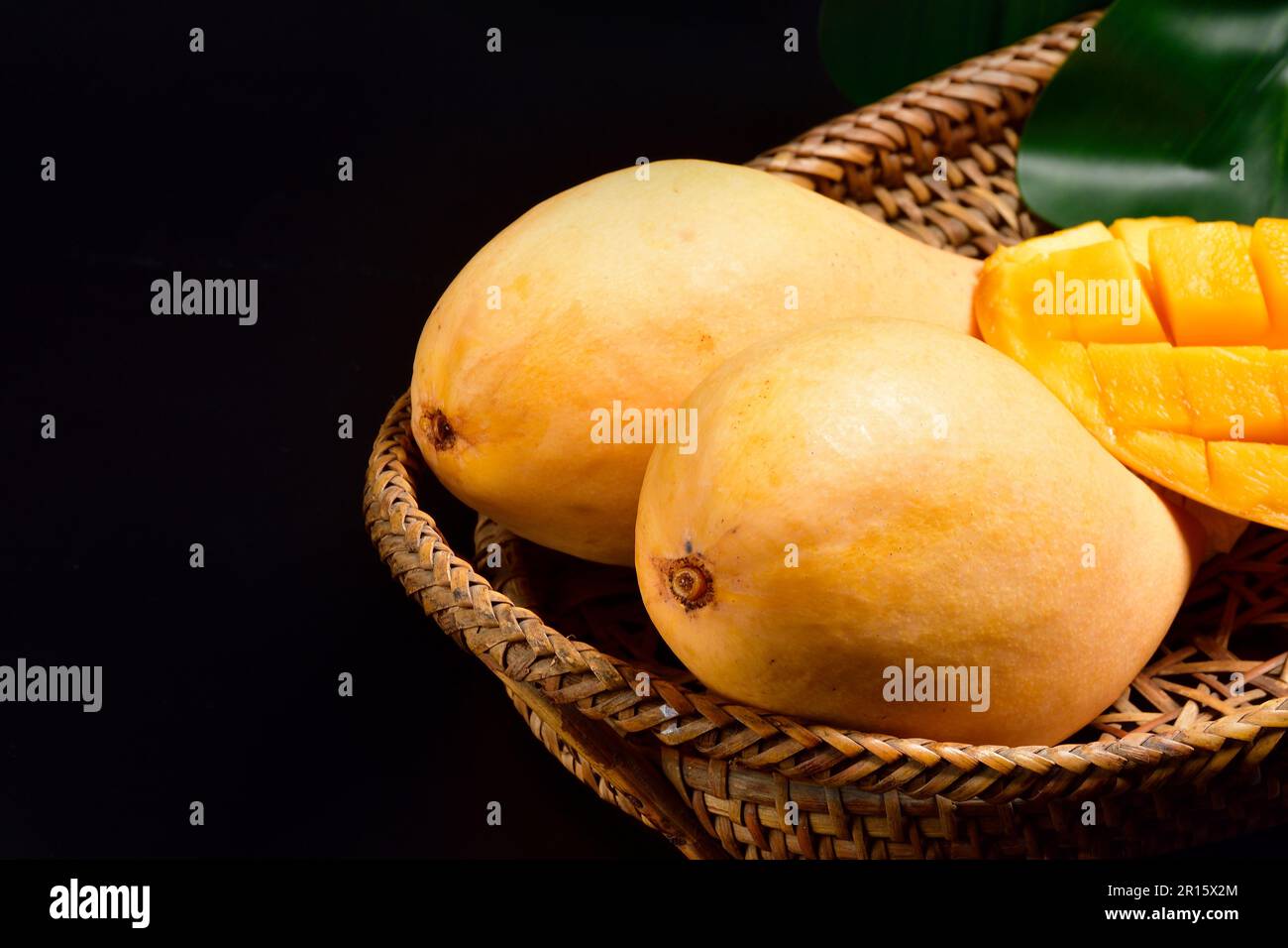 Fresh Thai Mango.Barracuda mango on the wicker basket. Food and drink ...