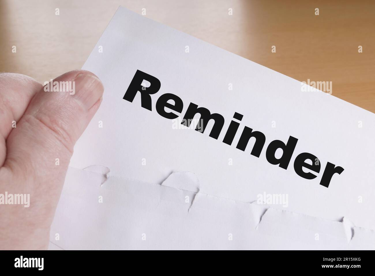 male hand holding reminder letter Stock Photo - Alamy