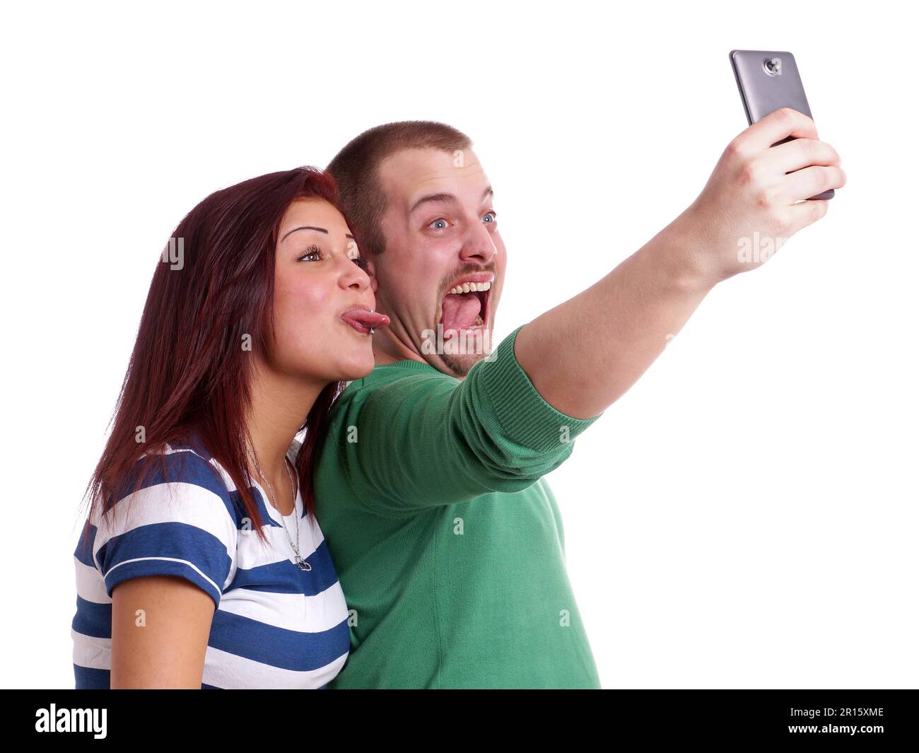 making silly faces while taking a self portrait with smart phone Stock ...