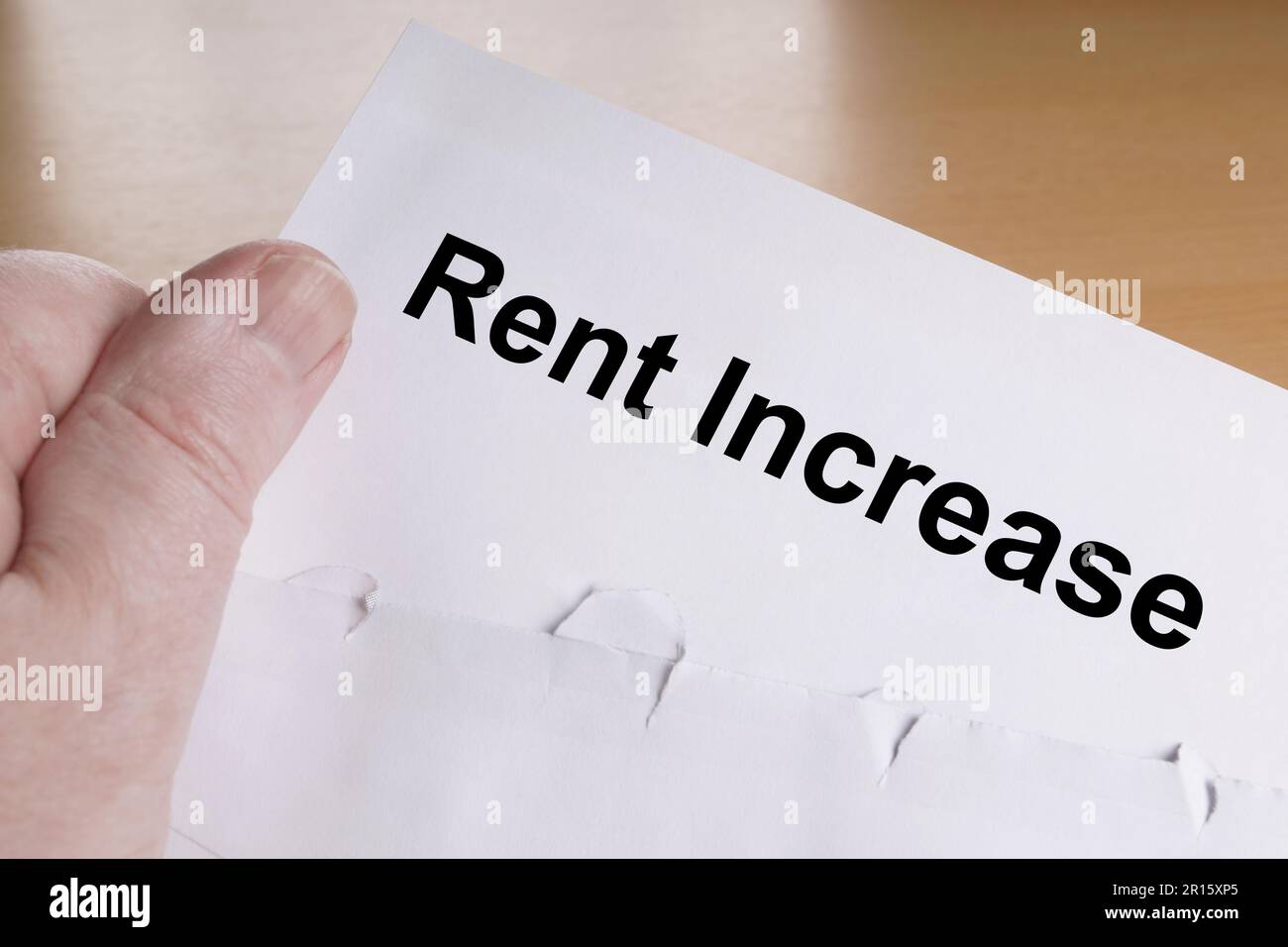 hand holding notice of rent increase letter Stock Photo - Alamy