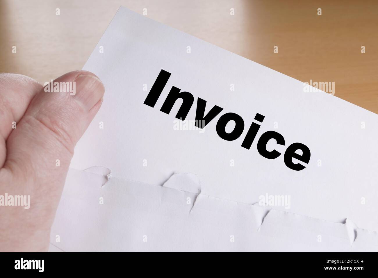 hand holding invoice letter with opened envelope Stock Photo - Alamy