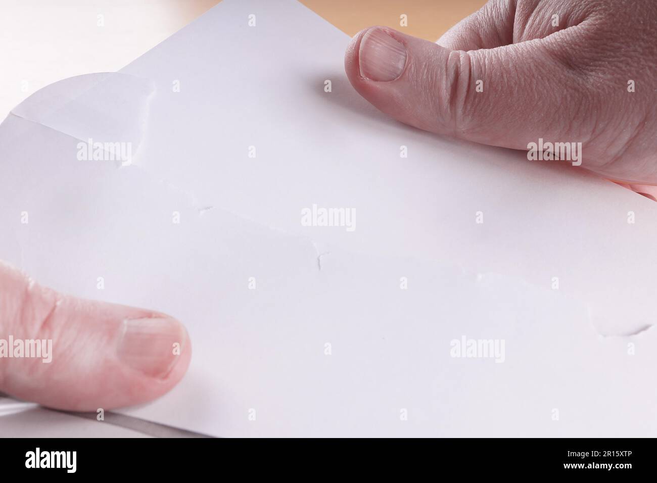 male hands opening envelope and pulling out blank letter Stock Photo ...
